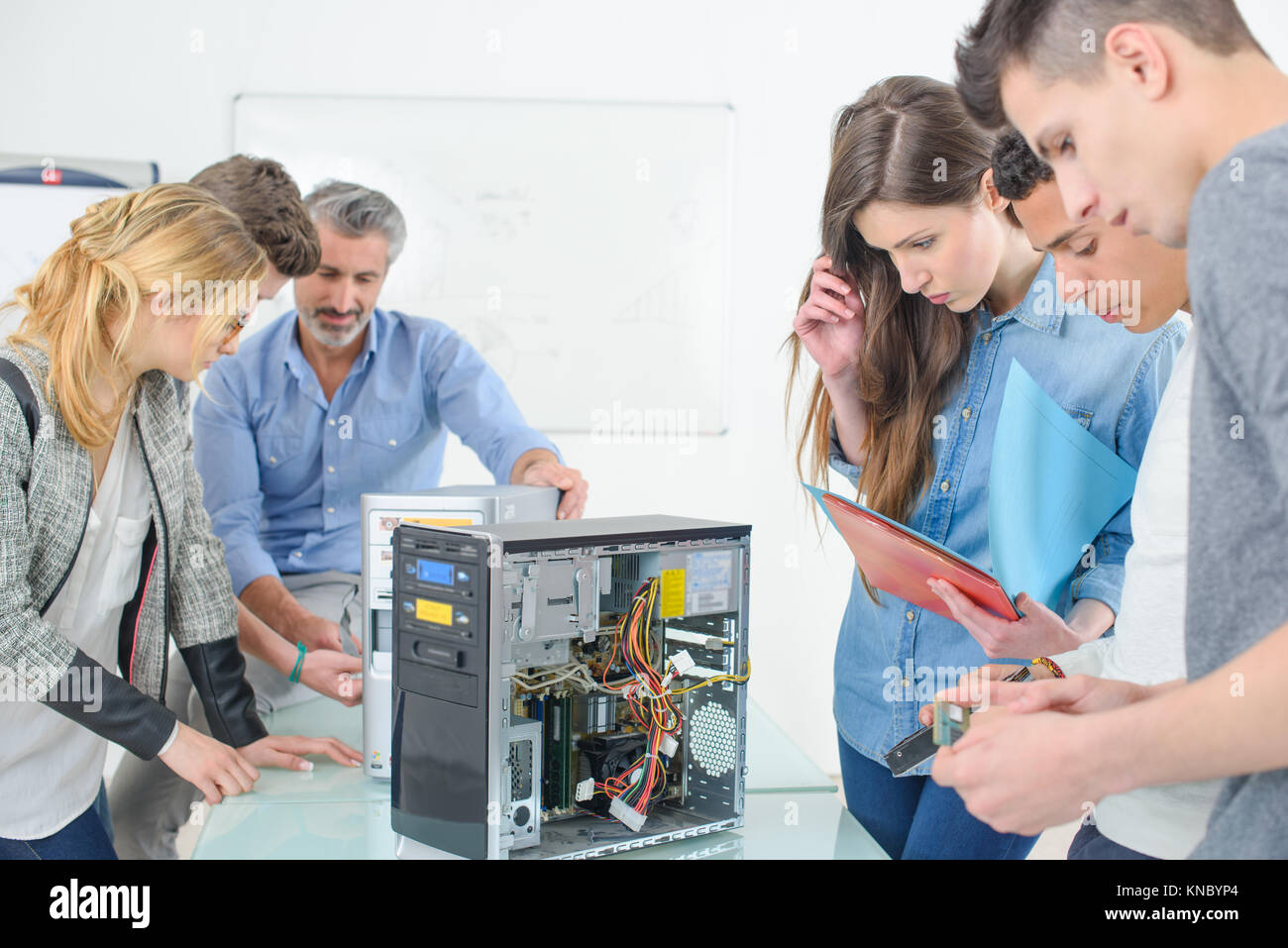 tutor and student fixing computer in class Stock Photo - Alamy
