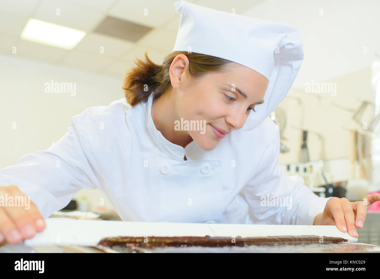 chef dividing a cake Stock Photo - Alamy
