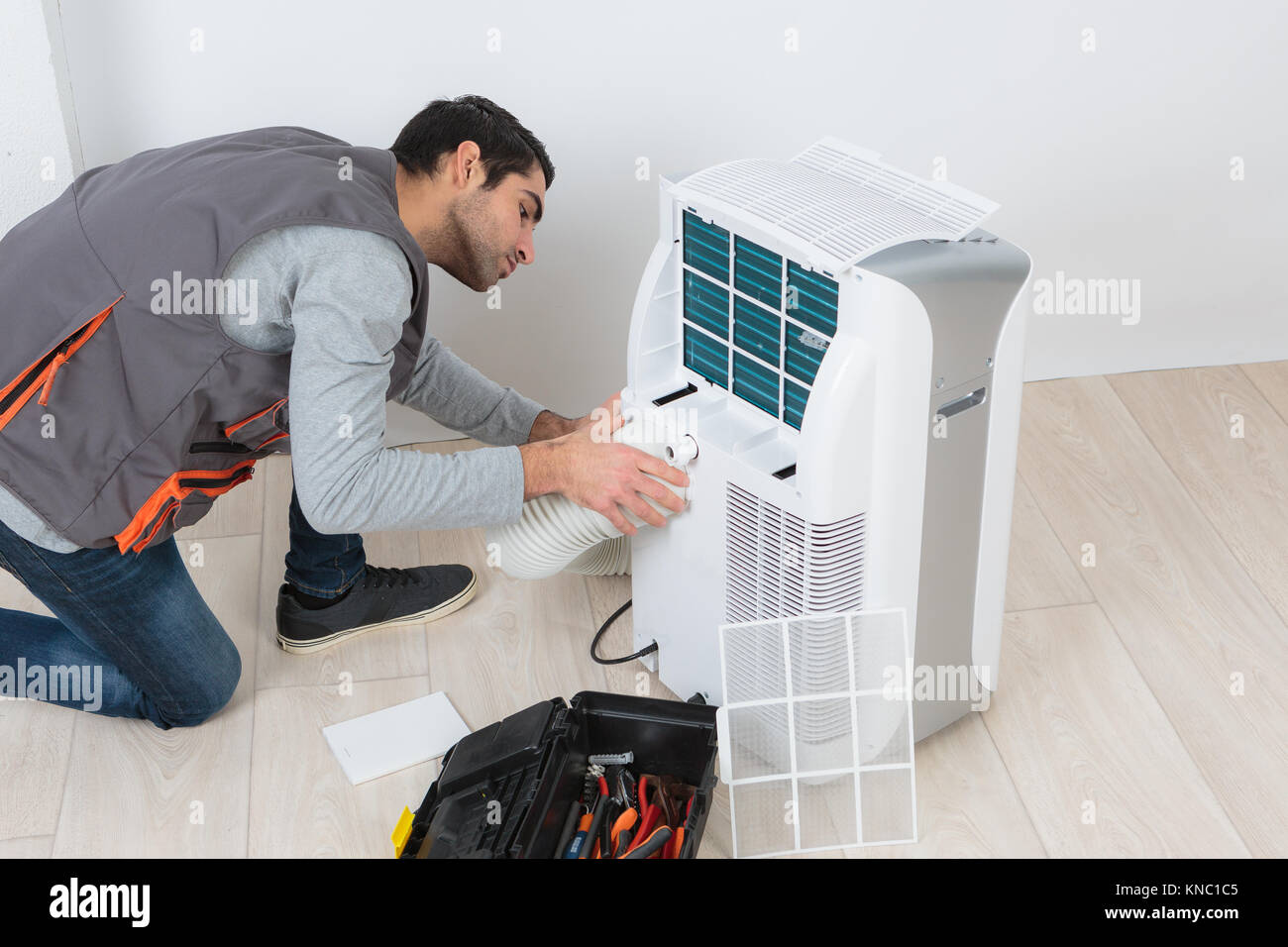 Man working on mobile air conditioning unit Stock Photo - Alamy