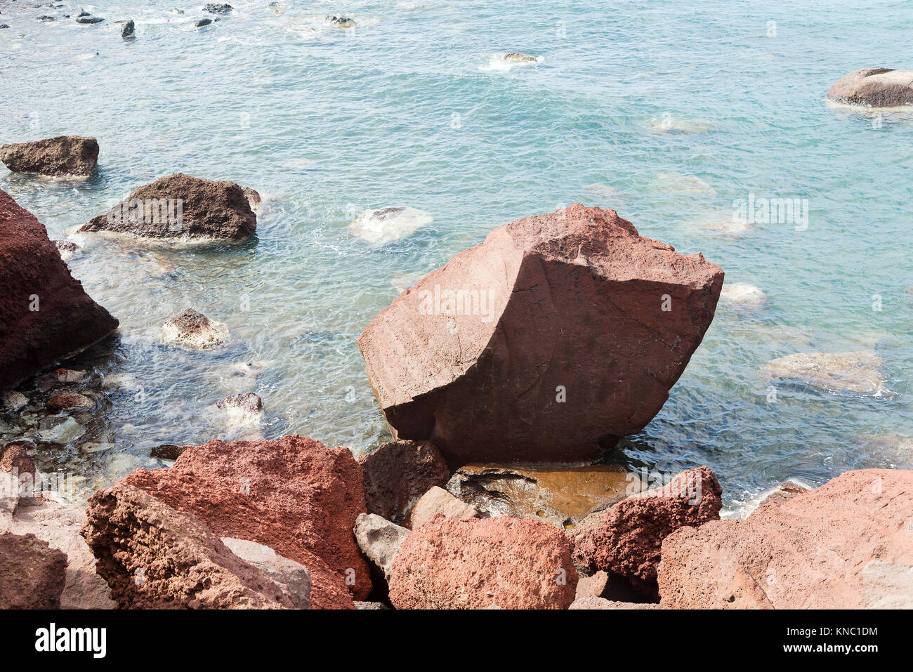 Beach with red sand. The island of Santorini. Volcanic rock, Greece ...