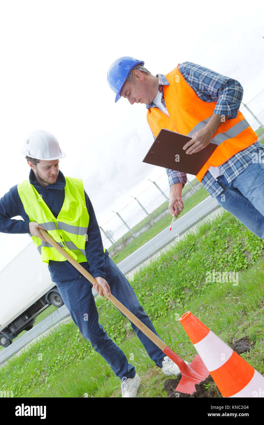 workers build concrete walkway in green field Stock Photo - Alamy