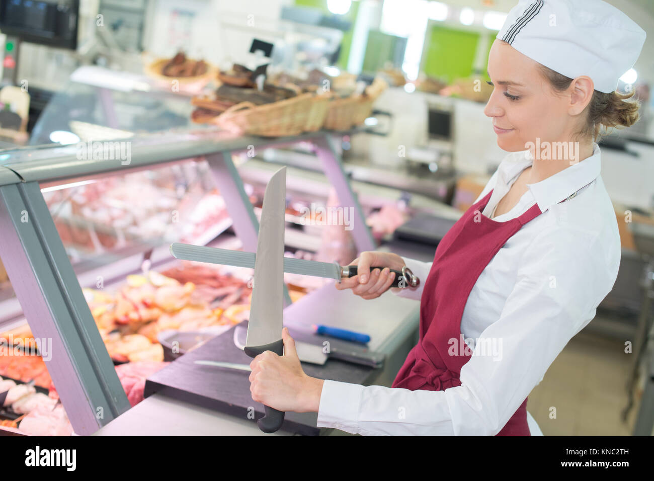 female butcher works at a supermarket Stock Photo - Alamy
