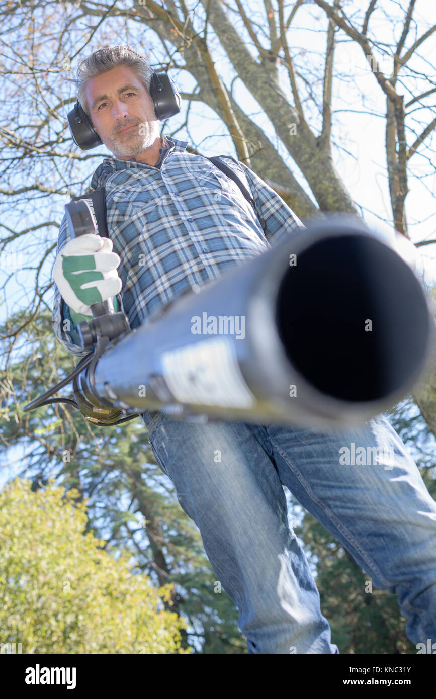 Upward view of leafblower held by man Stock Photo - Alamy
