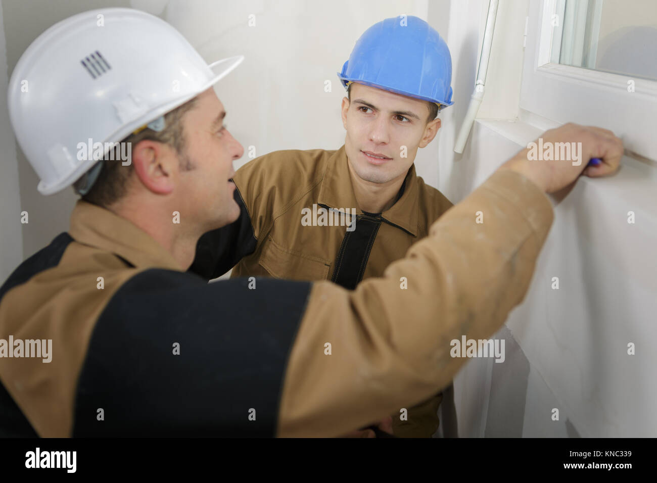 Two workmen by pvc window Stock Photo - Alamy