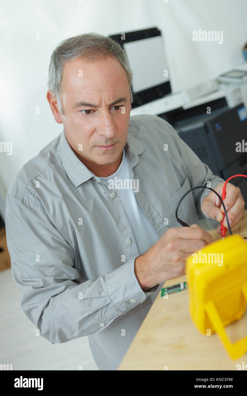 mature man using multimeter Stock Photo - Alamy