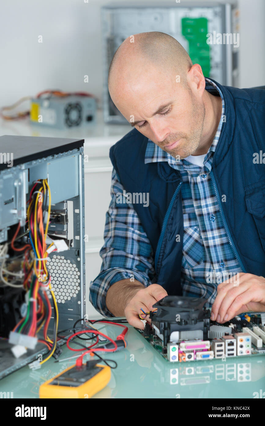 young man repairing computer hardware in service center Stock Photo - Alamy