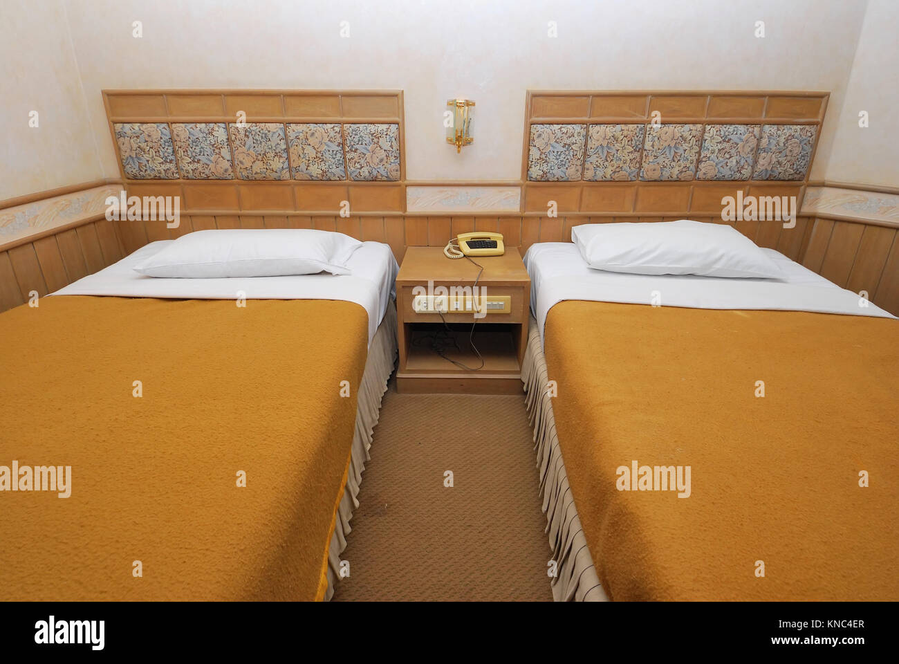 Twin beds neatly done up in a high class hotel room. Suitable for ...