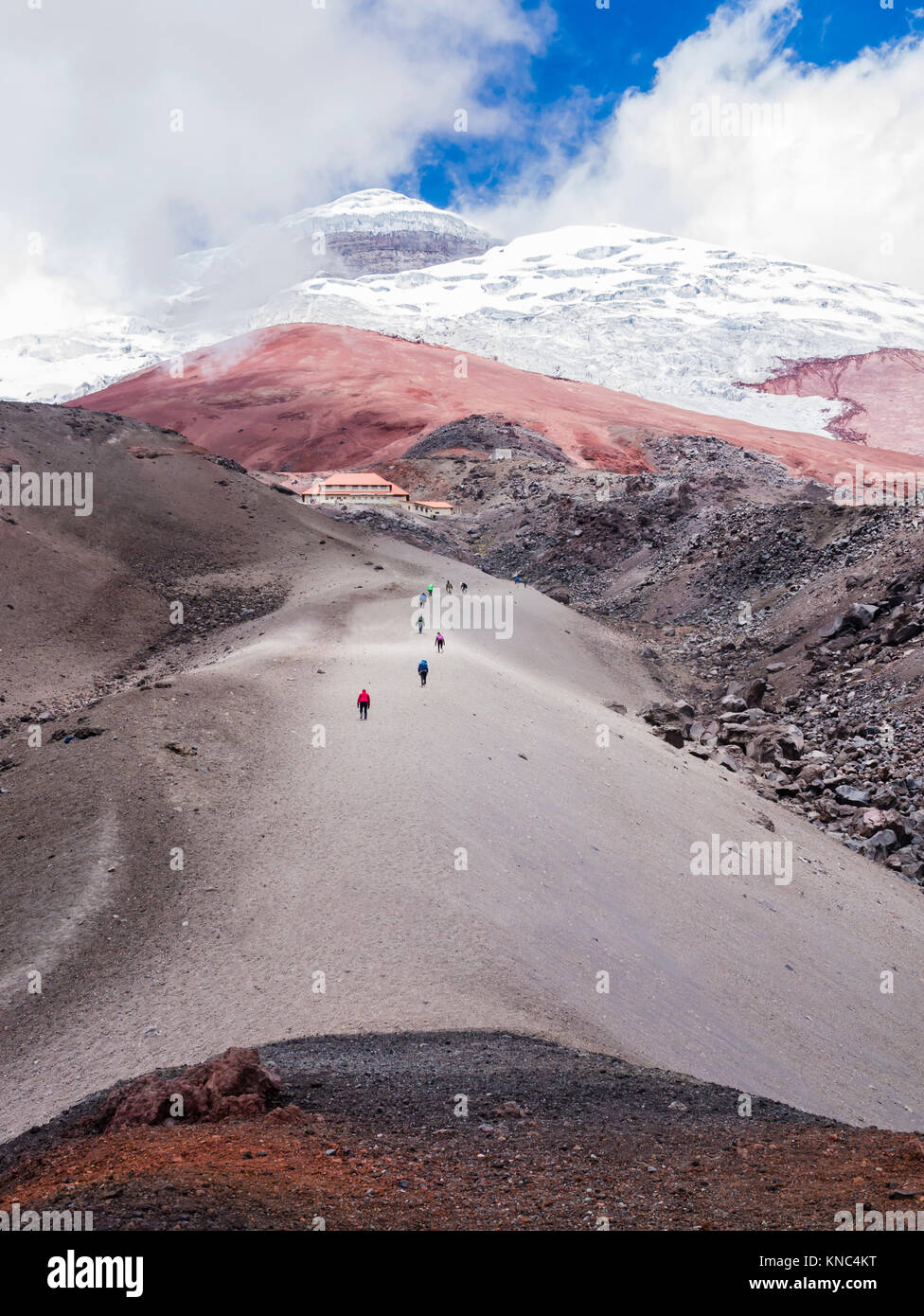 Backpackers climbing Cotopaxi volcano along a pyroclastic rocks hiking ...