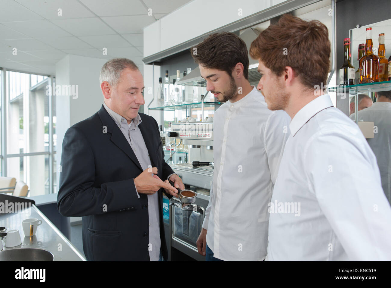 bar manager talking to staff memebers Stock Photo - Alamy