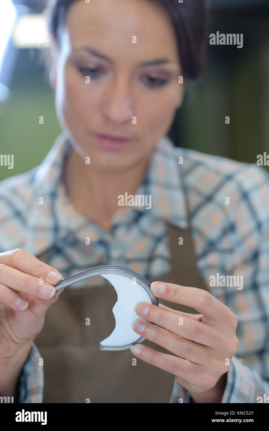 Female artist making crescent shaped object Stock Photo - Alamy