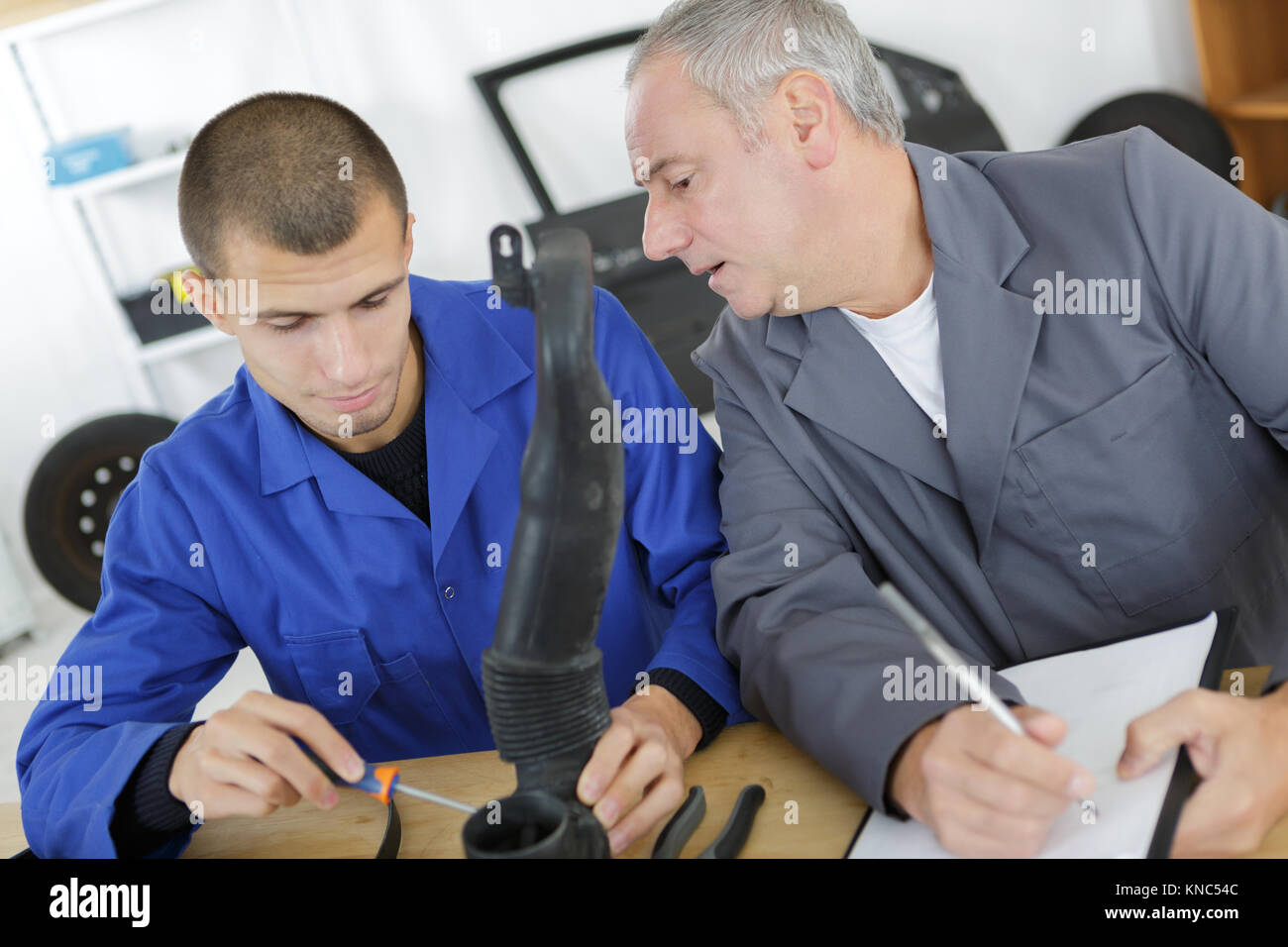 student with teacher during automotive class Stock Photo - Alamy