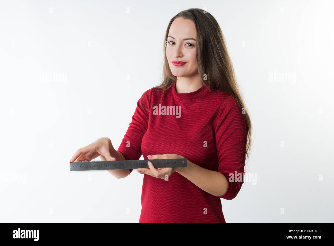 young beautiful woman measures something with ruler Stock Photo - Alamy