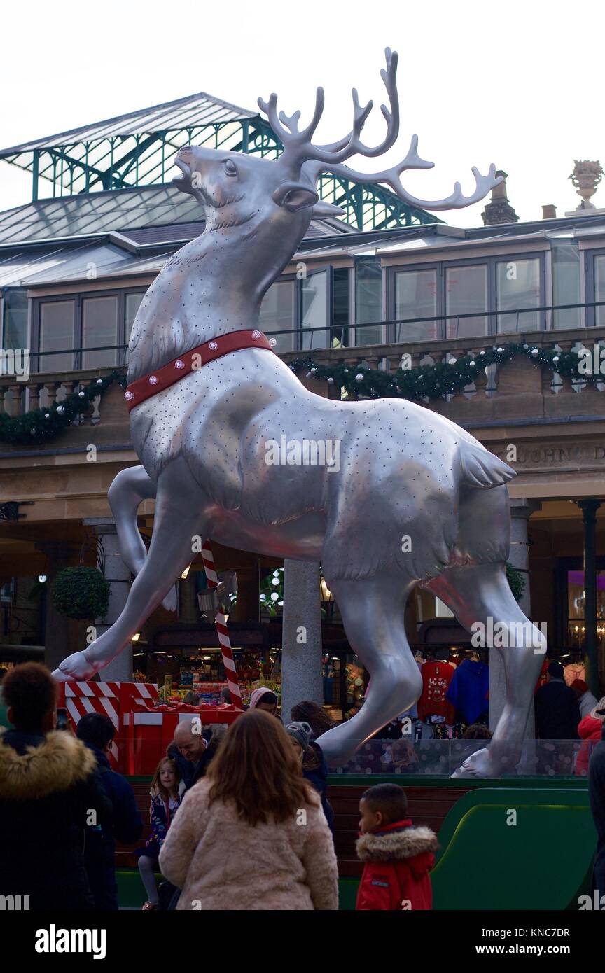Giant silver reindeer in Covent Garden at Christmas with shoppers ...