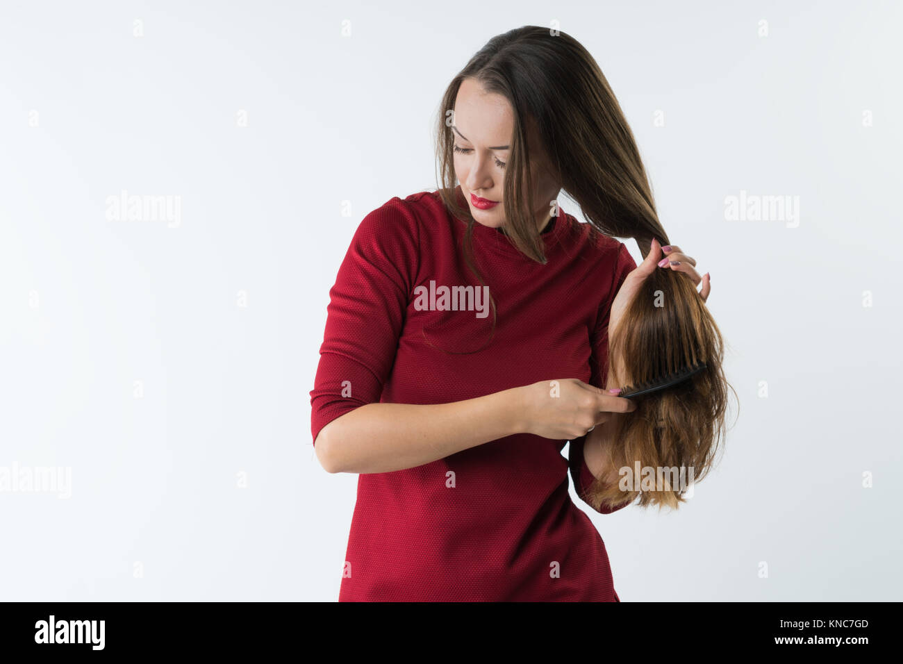 beautiful stylish young girl combs her hair with a comb Stock Photo - Alamy