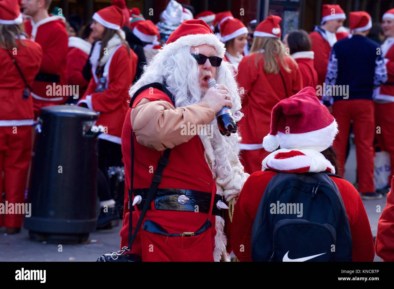 Flash mob dressed as Santa Claus walking through London, drinking and ...