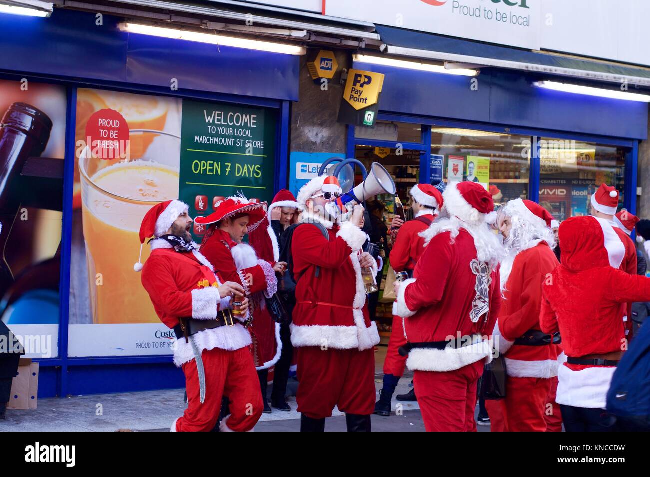 Flash mob dressed as Santa Claus walking through London, drinking and ...