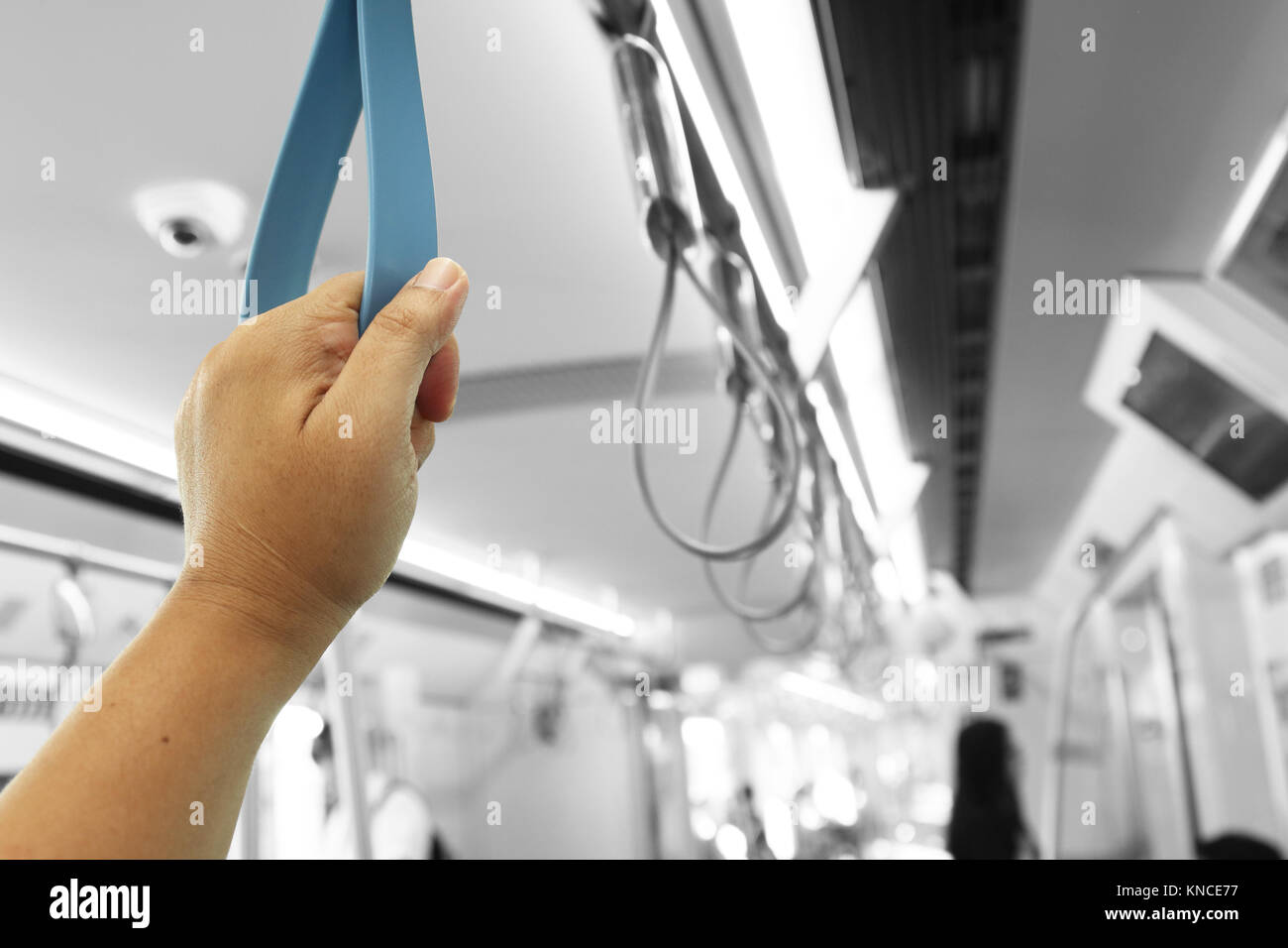 hand holding a handle on a train Stock Photo - Alamy