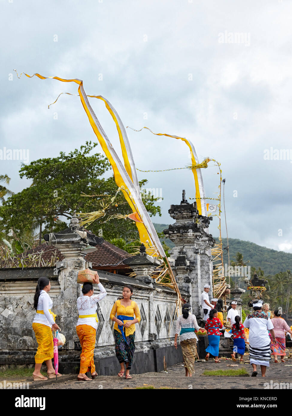 People wearing traditional Balinese clothing in front of a local temple ...