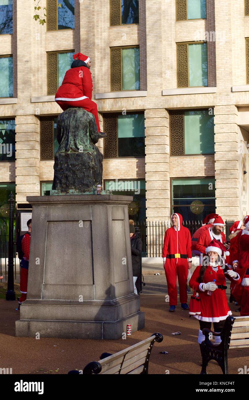 Flash mob dressed as Santa Claus walking through London, drinking and ...