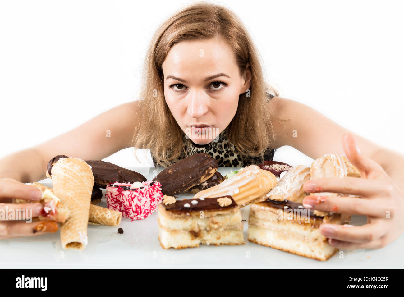 Young woman eating cupcakes with pleasure after a diet Stock Photo - Alamy