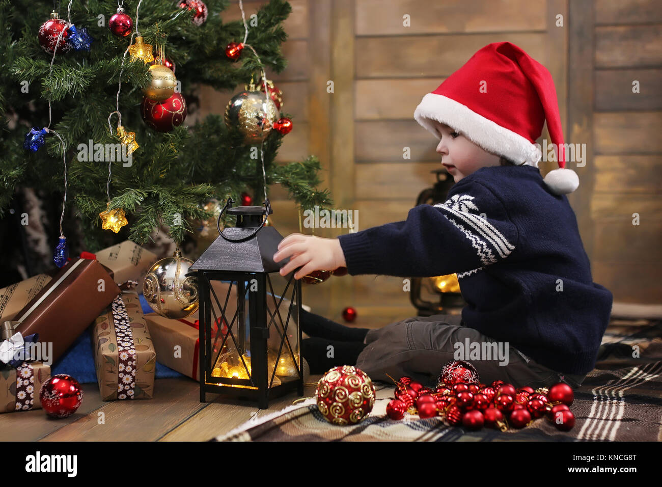 little child and Christmas toys Stock Photo - Alamy