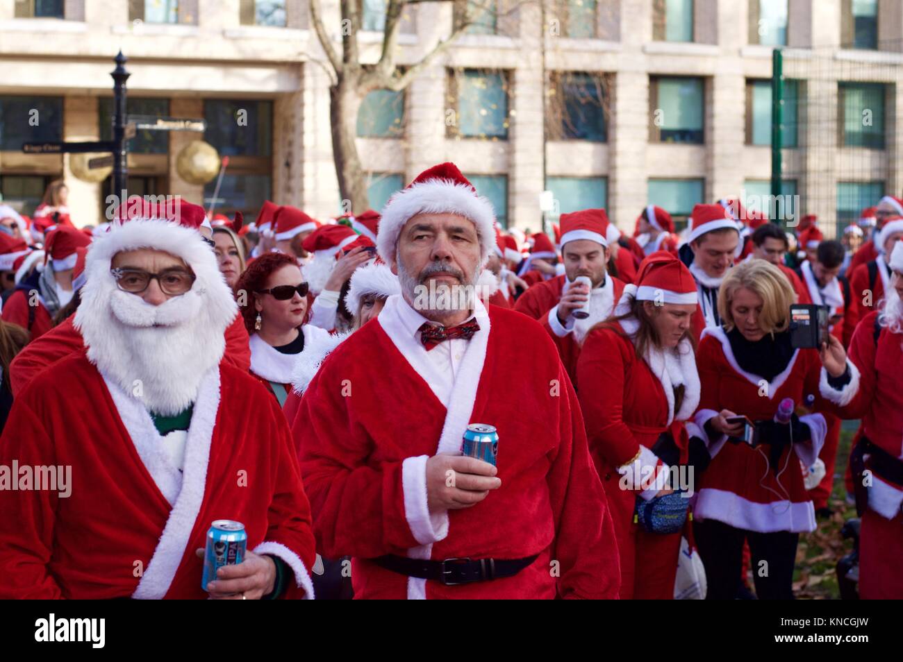 Flash mob dressed as Santa Claus walking through London, drinking and ...