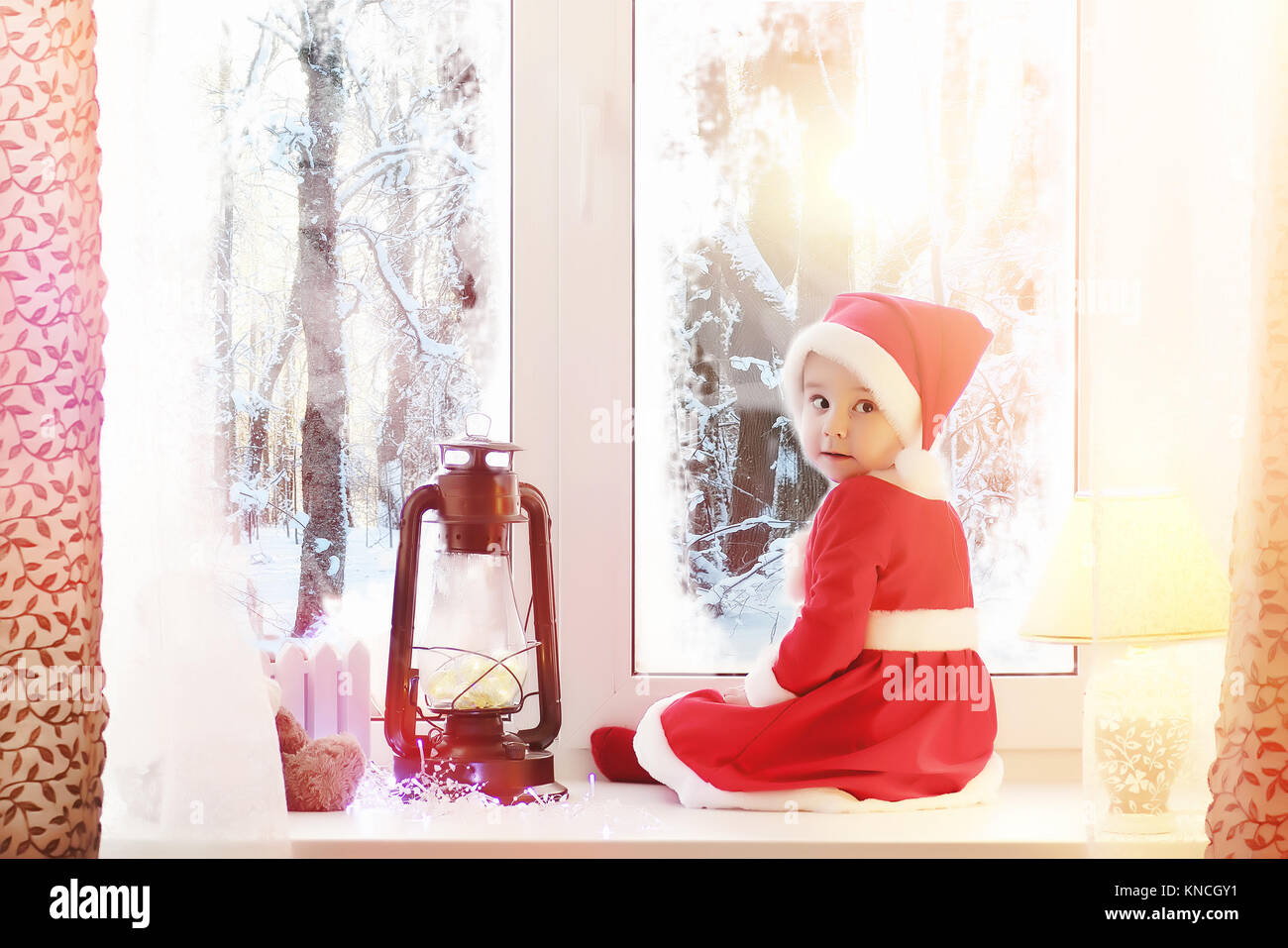 A child in the new year looks out the window. Children are waiti Stock ...
