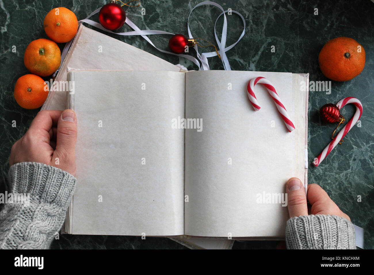 pages opened vintage book on green marble countertop Stock Photo - Alamy