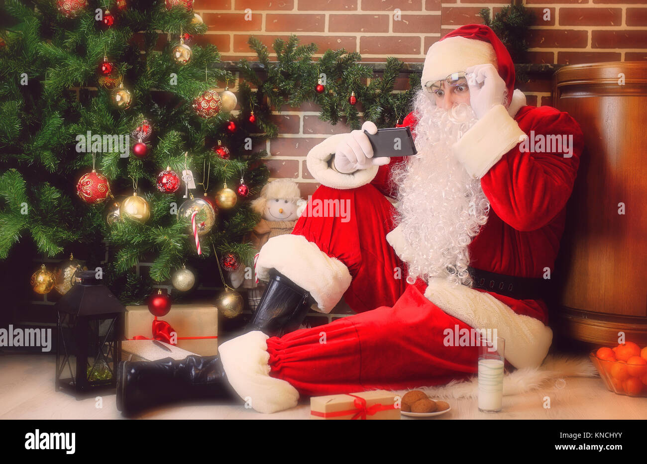 Santa Claus with Christmas tree Stock Photo - Alamy