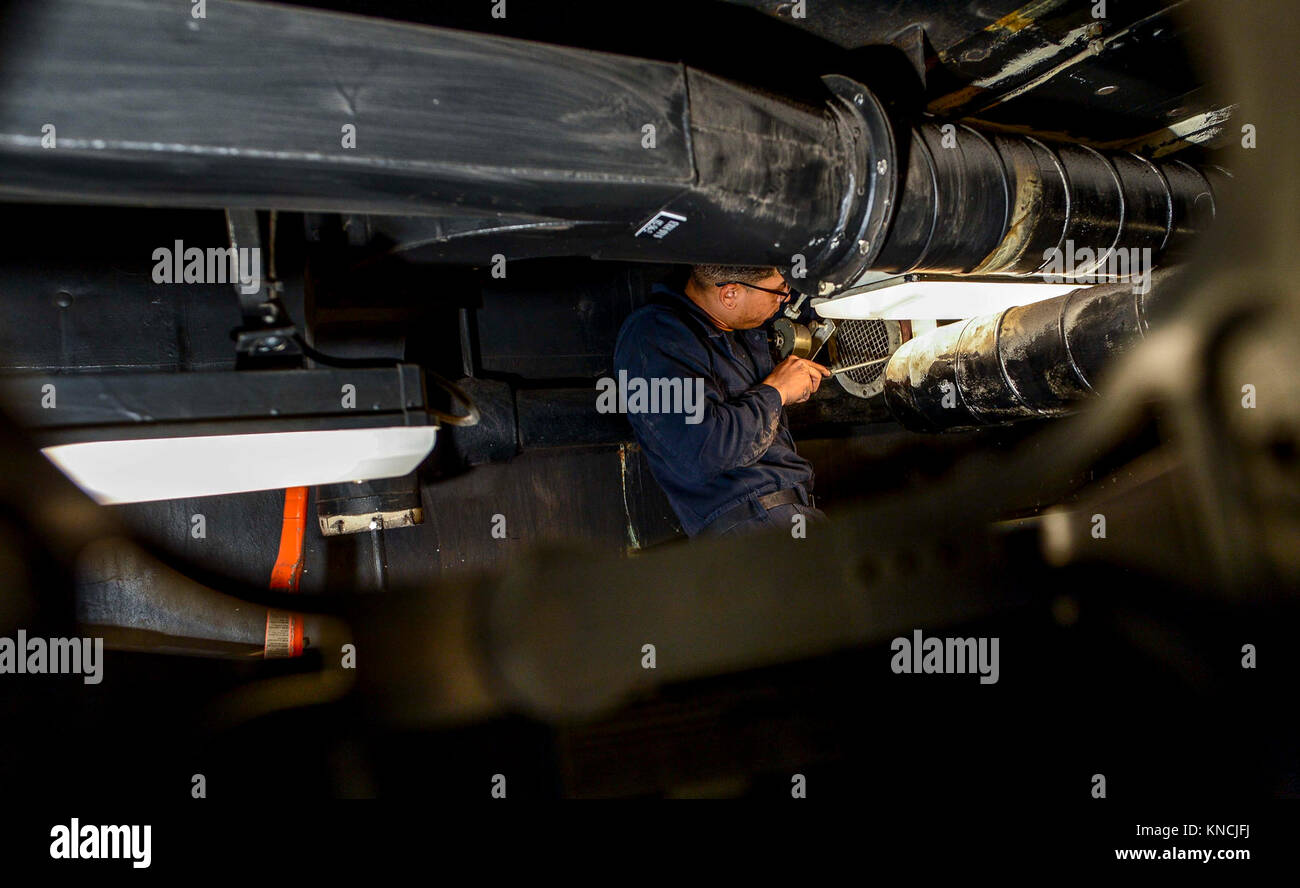 Hull Maintenance Technician 3rd Class Luis Leon conducts maintenance on ...