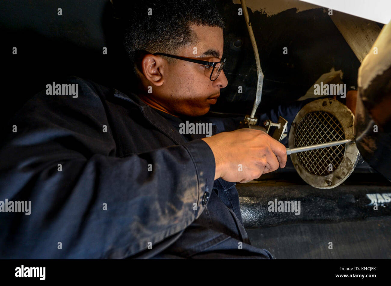 Hull Maintenance Technician 3rd Class Luis Leon conducts maintenance on ...