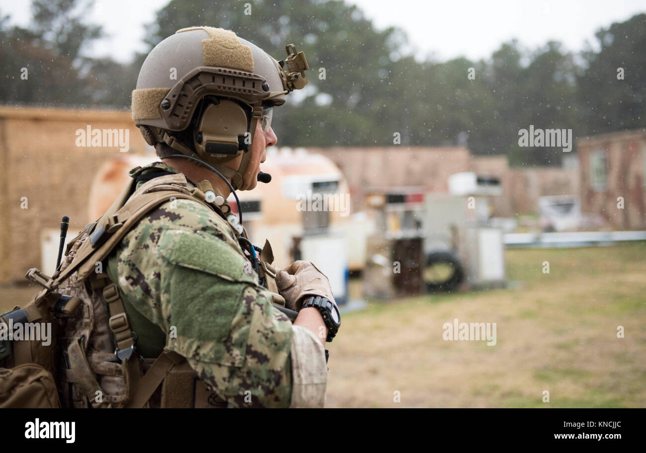 A U.S. Navy explosive ordnance disposal technician transmits a radio ...