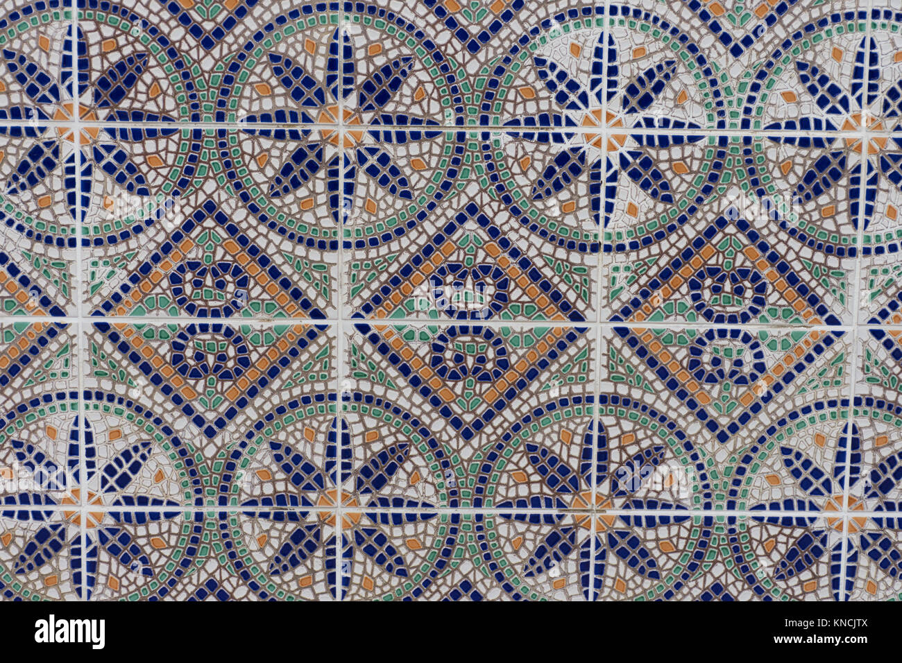 Close up of a colorful mosaic tile wall with orange, green, blue and ...