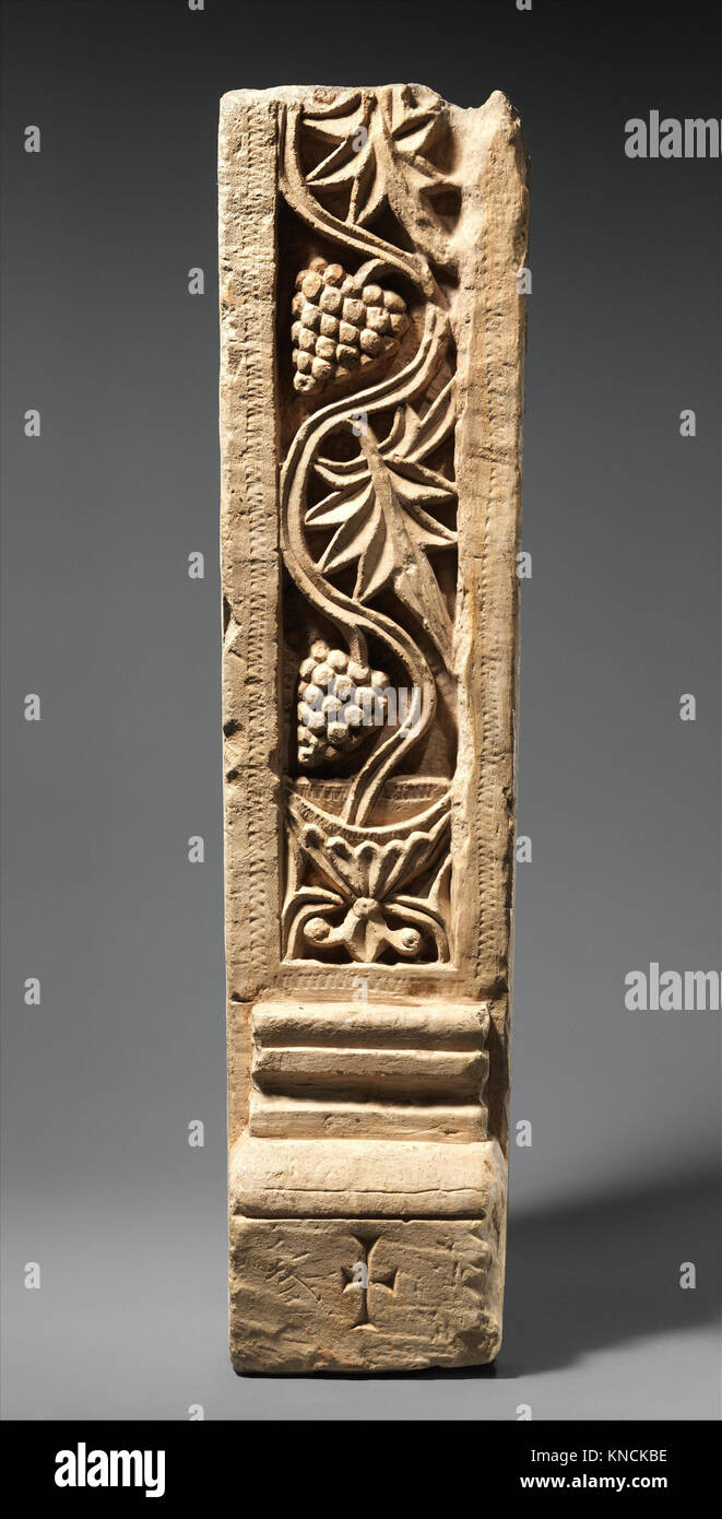 This ancient door post features intricate carvings of a grapevine ...