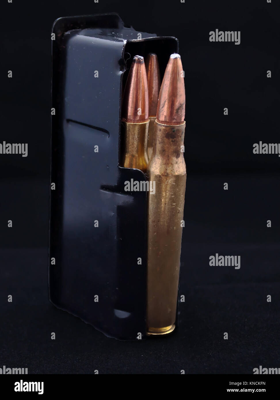 A fully loaded rifle magazine stood up on a black background Stock ...