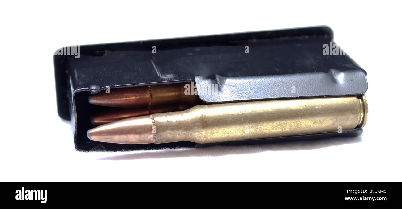 A fully loaded rifle magazine laying on it's side on a white background ...