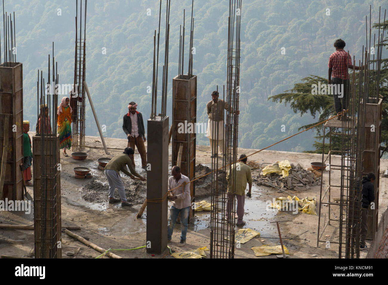 Indian construction workers building a concrete building in Mcleod Ganj ...