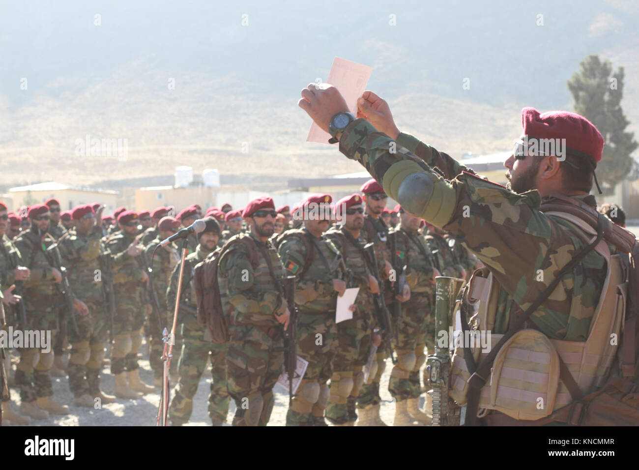 An Afghan Commando presents his course certificate to his fellow ...