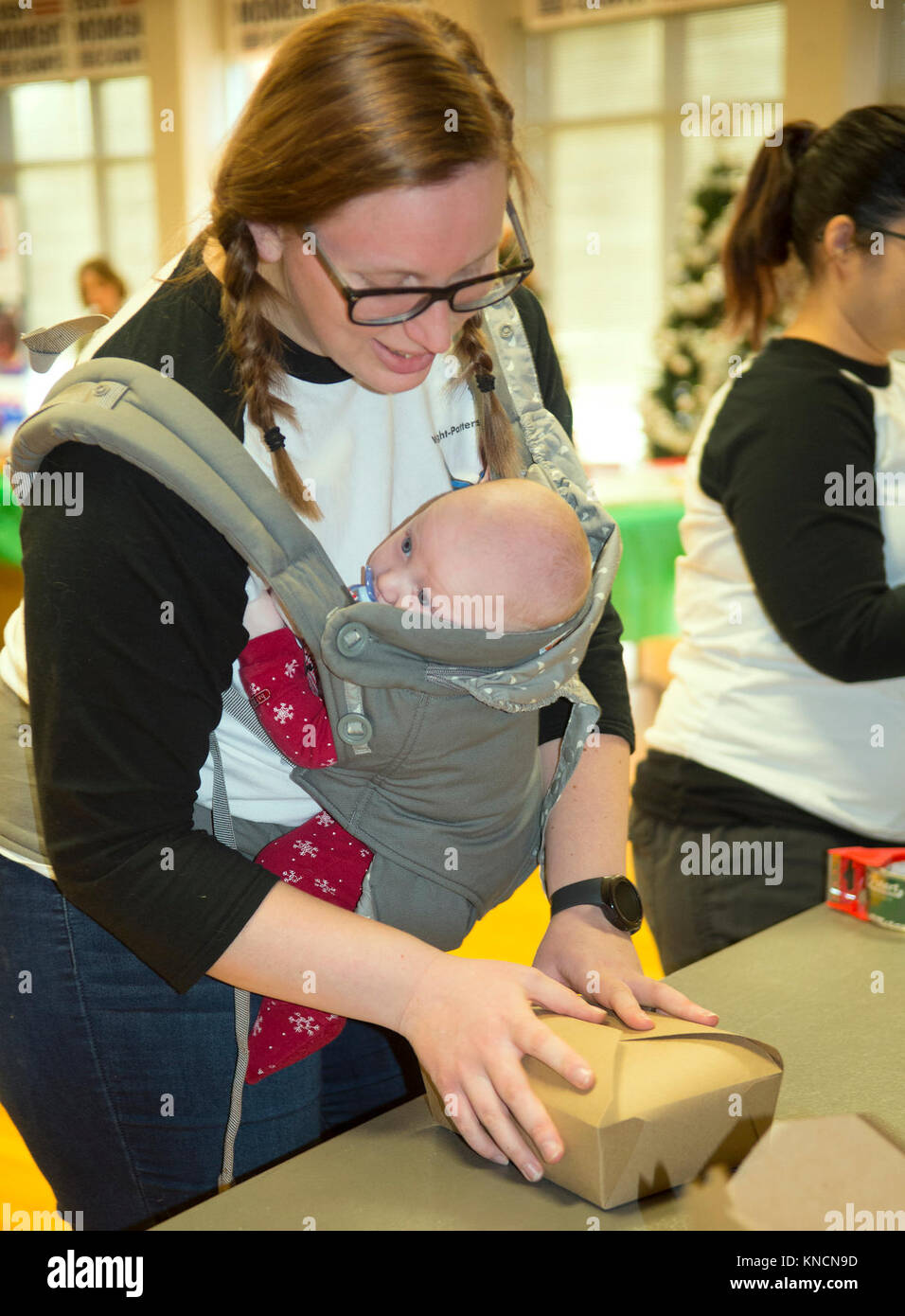 Erica Coleman and her son Lance, 2 ½ months, seal up a pack of donated ...