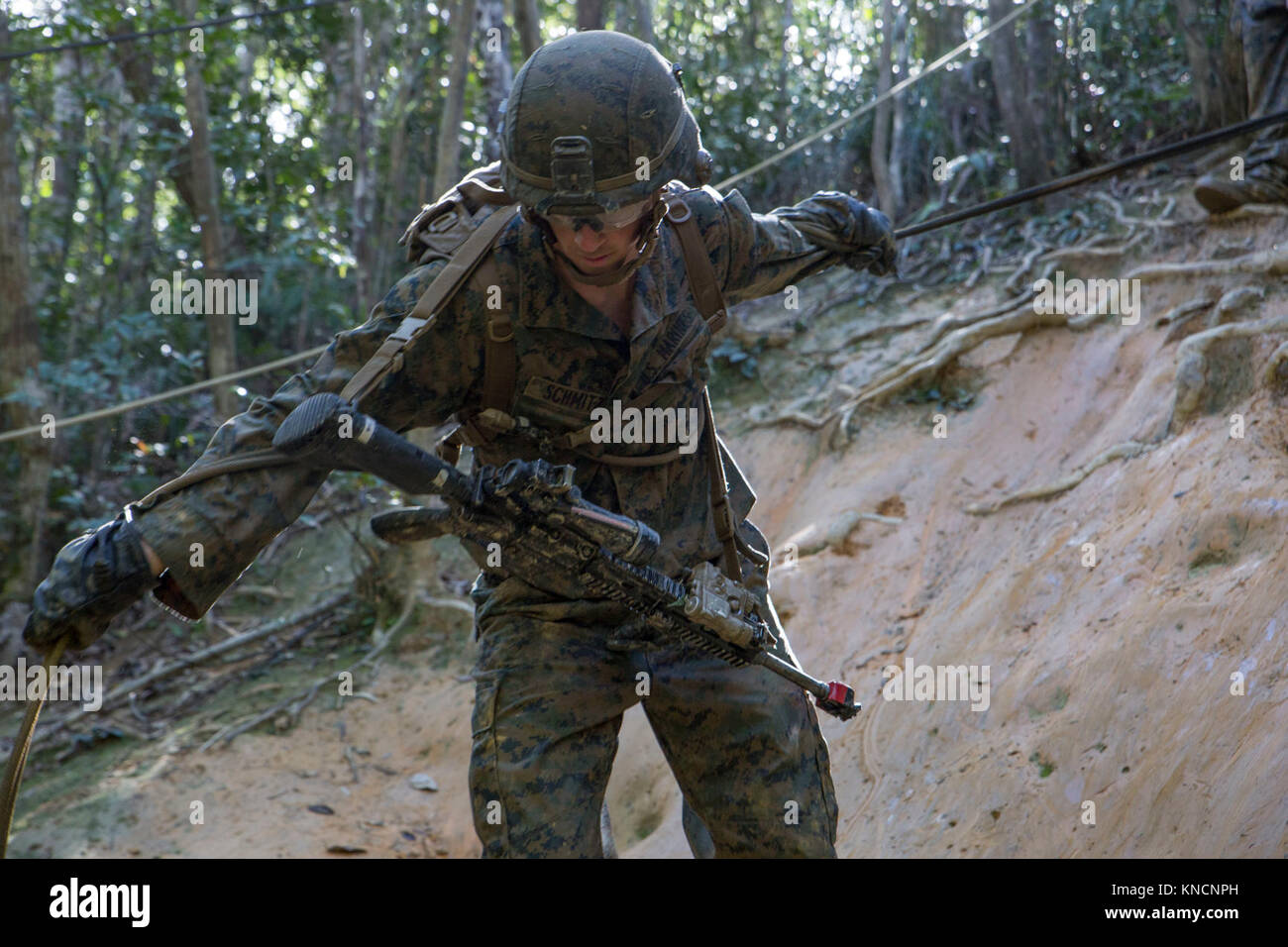A U.S. Marine overcomes a hasty rappel obstacle during the 3rd Marine ...