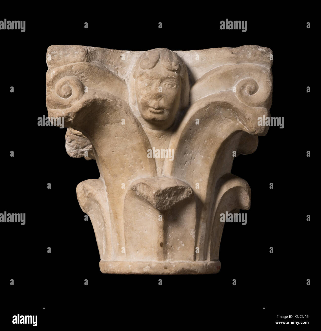 A double capital, featuring two connected carved elements, representing ...