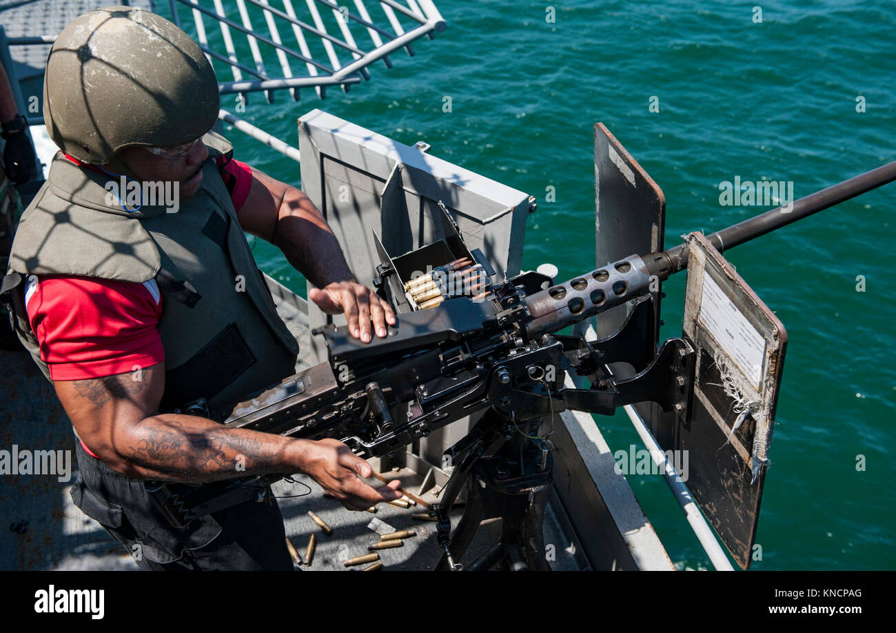 Culinary Specialist 2nd Class Derrick Bates reloads an M2HB .50 caliber ...