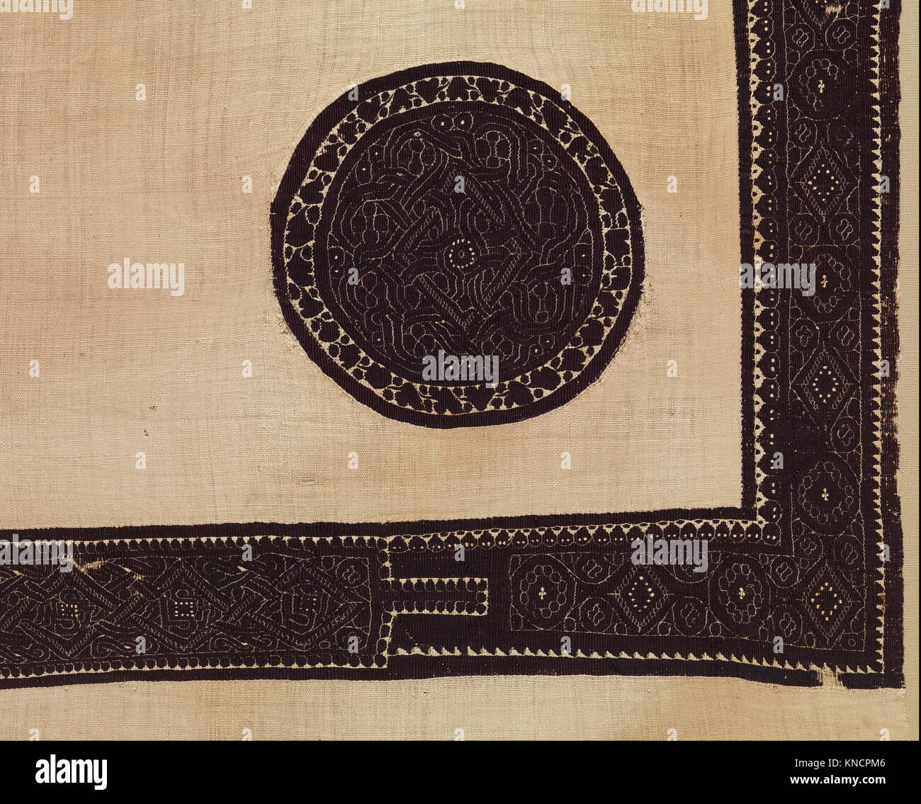 A fragment featuring a roundel and L-shaped band with interlace ...