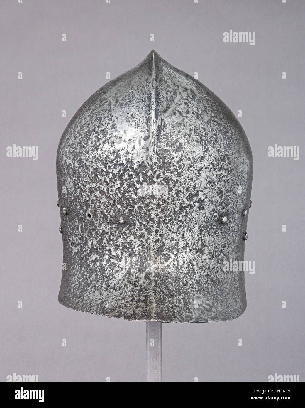 This barbute helmet, originating from the medieval period, is ...