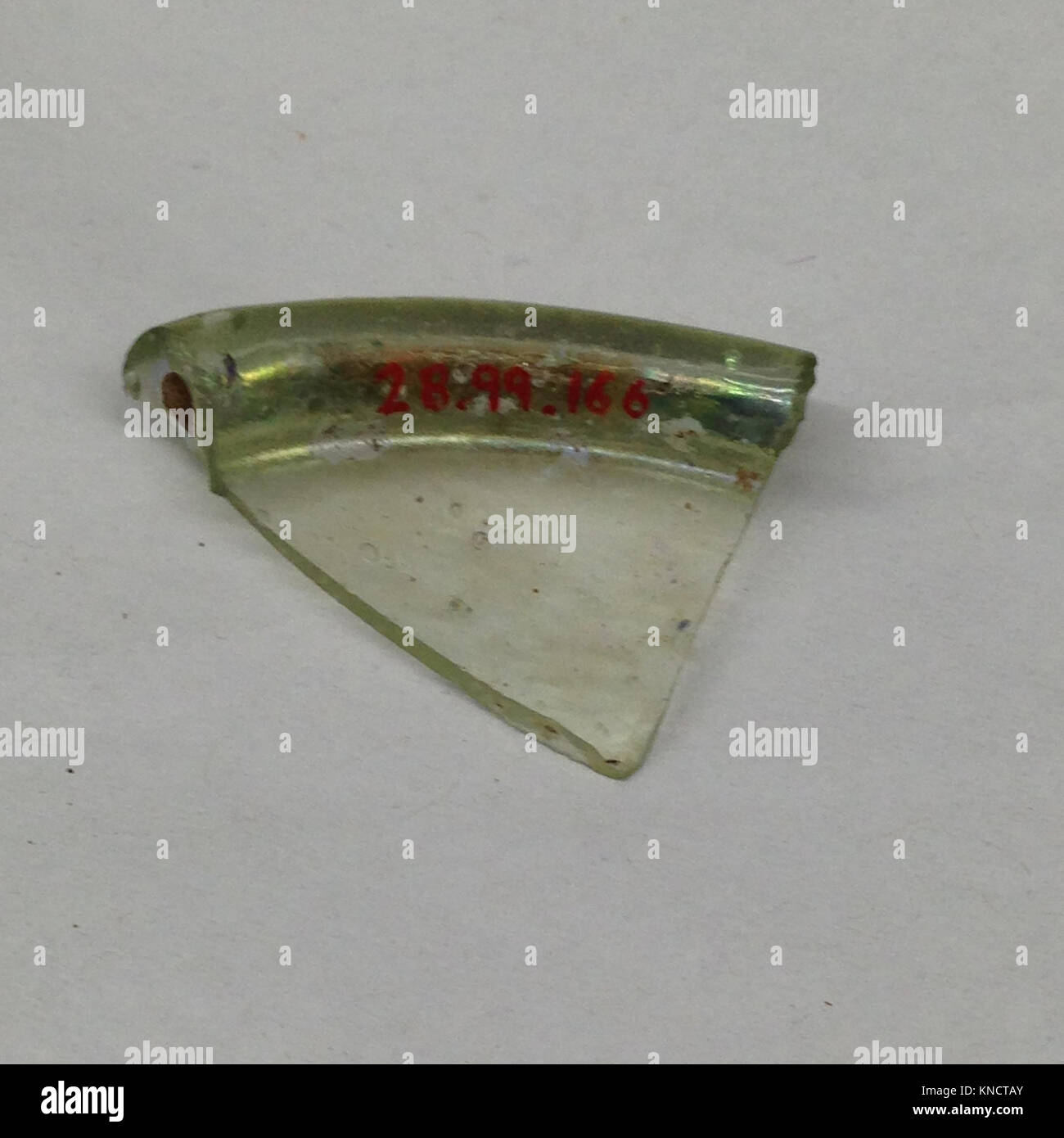 A small ceramic fragment, likely from a larger vessel, with distinctive ...