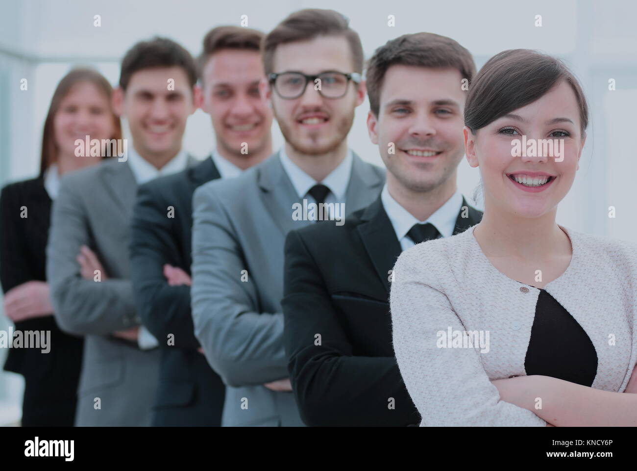 closeup of a smiling business team of six people standing in the column ...