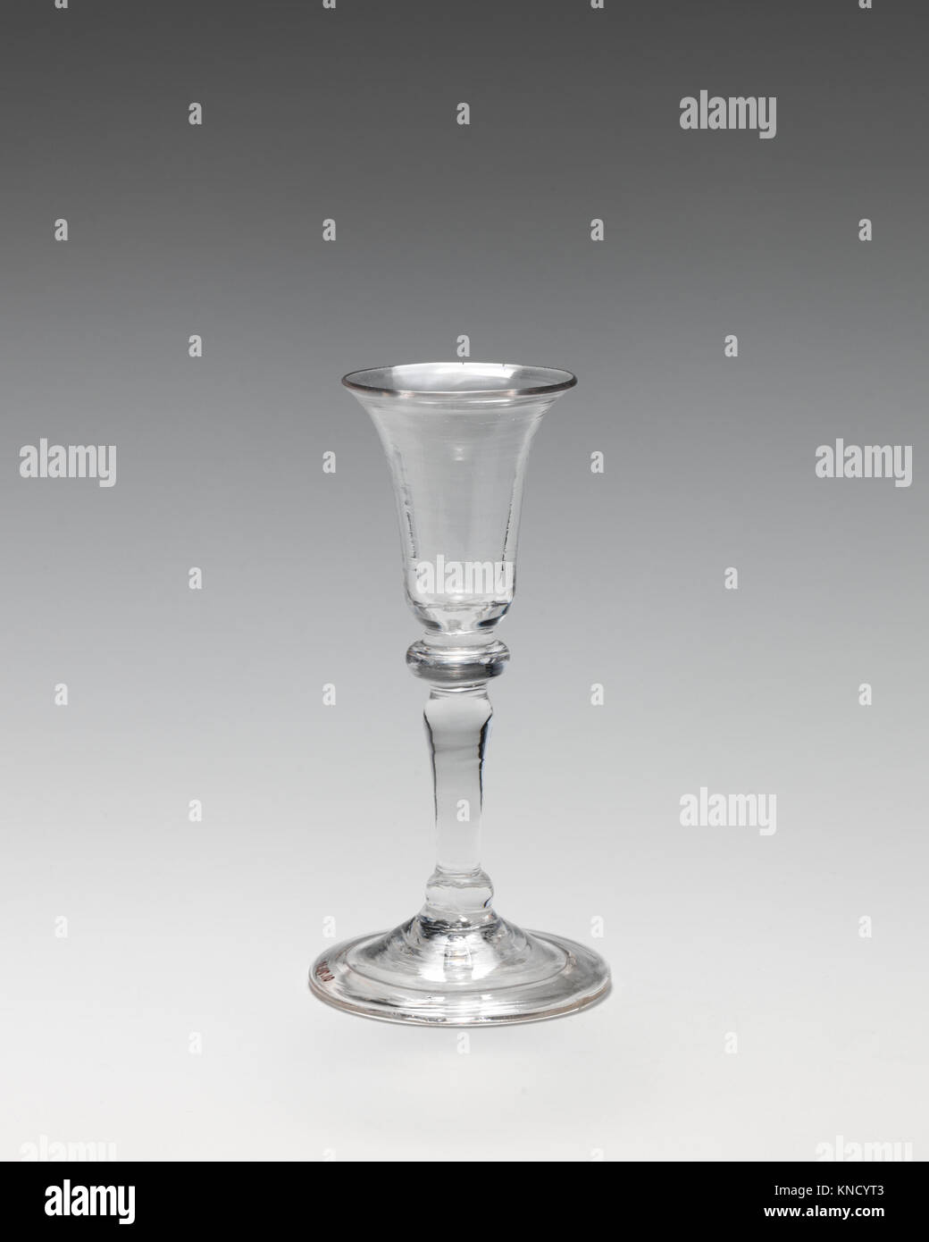 This cordial glass, crafted with fine glasswork, was used to serve ...