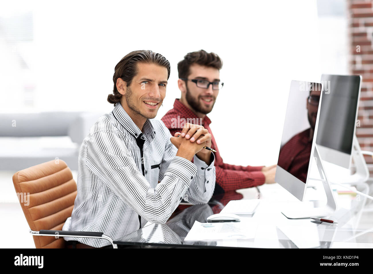 Two employees talking sitting table hi-res stock photography and images ...