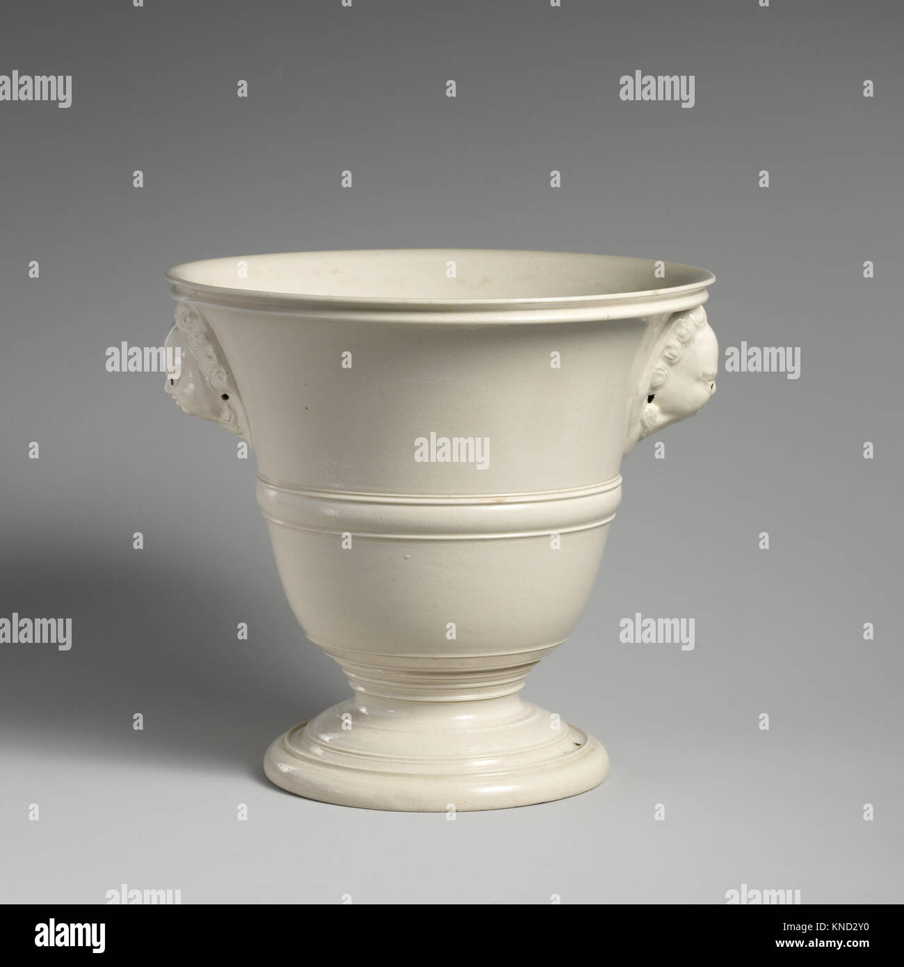 This cachepot, a decorative pot used for holding plants, features ...