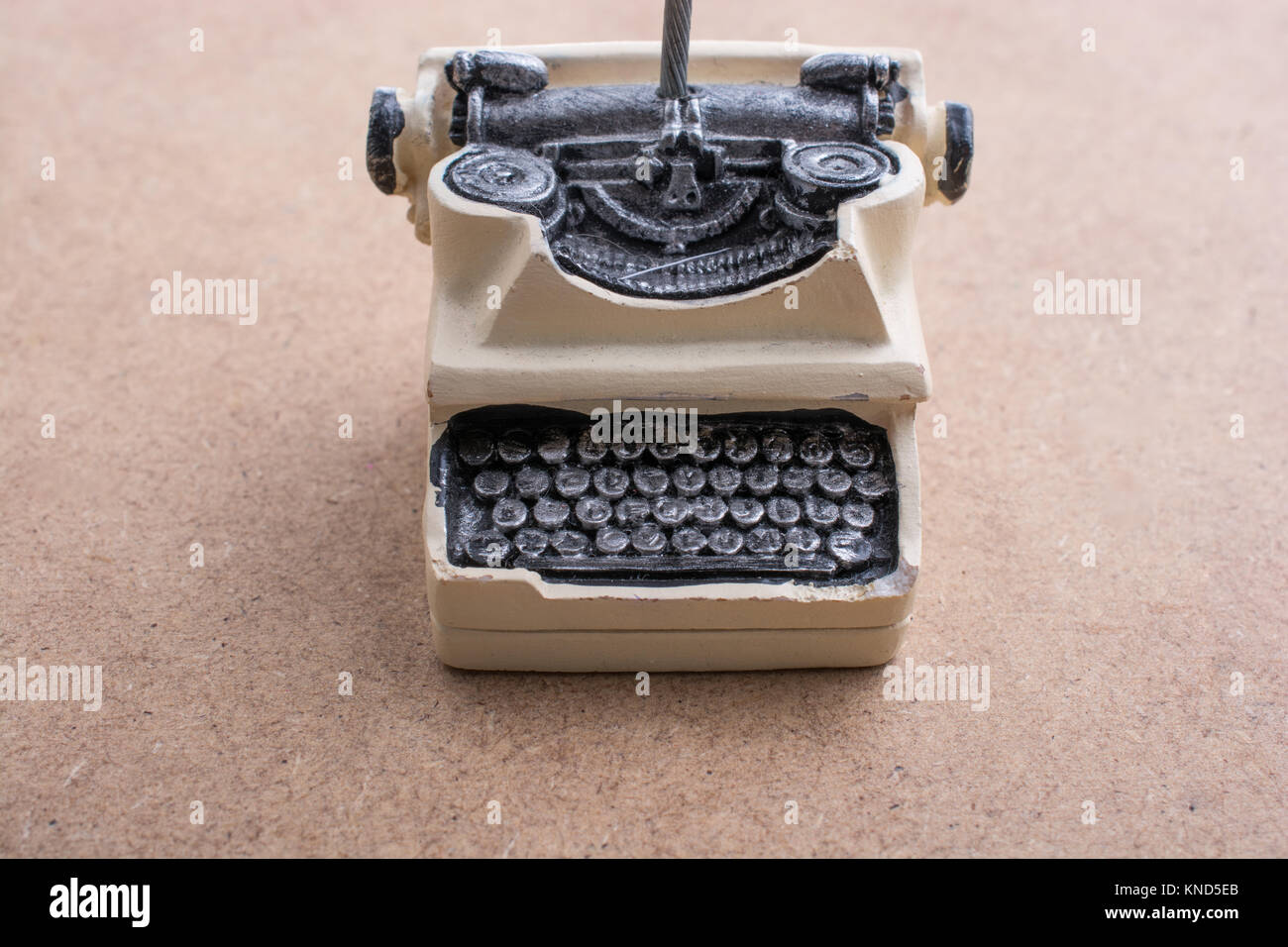 Retro syled tiny typewriter model on a brown background Stock Photo - Alamy